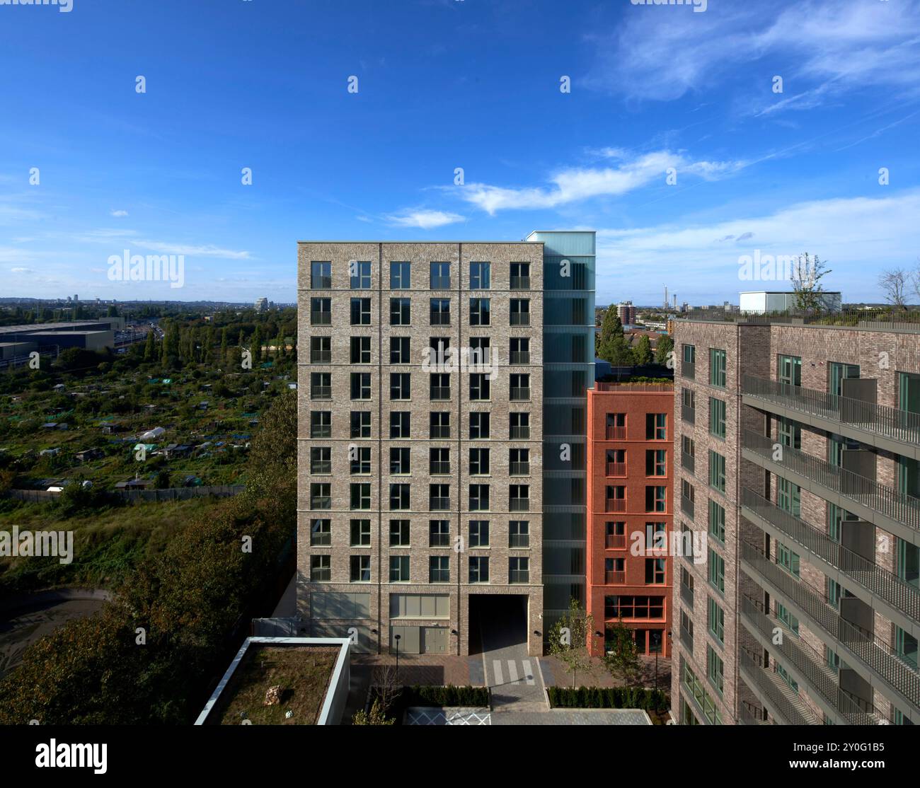 Apartment blocks of varying heights and roof gardens. Osier Way, London ...