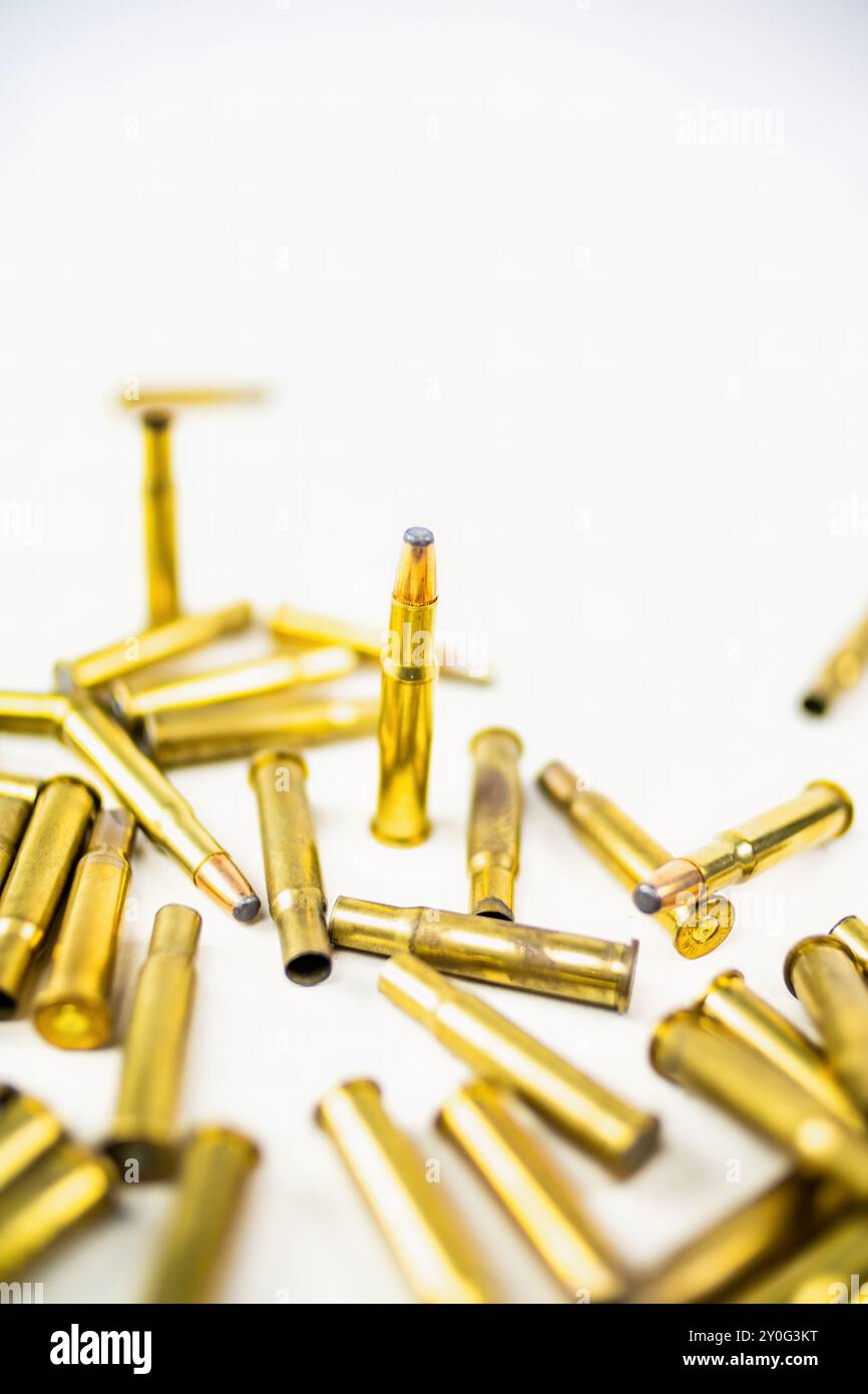 Gold Rifle Cartridges or empty casings Falling into a Pile on White ...