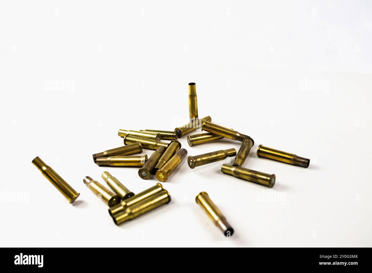 Gold Rifle Cartridges or empty casings Falling into a Pile on White ...