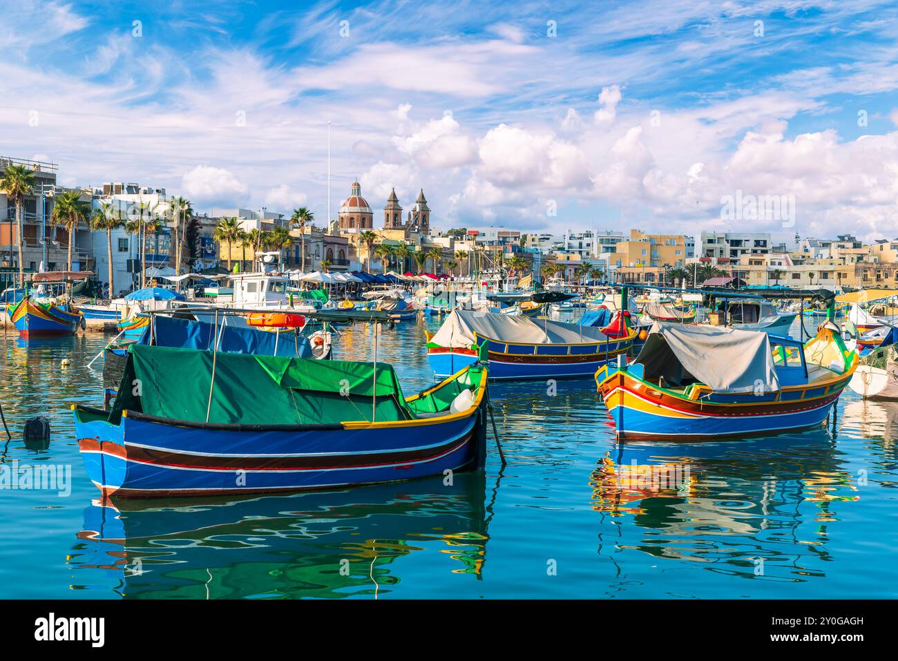 Picturesque fishing village with colorful traditional Luzzu boats in ...