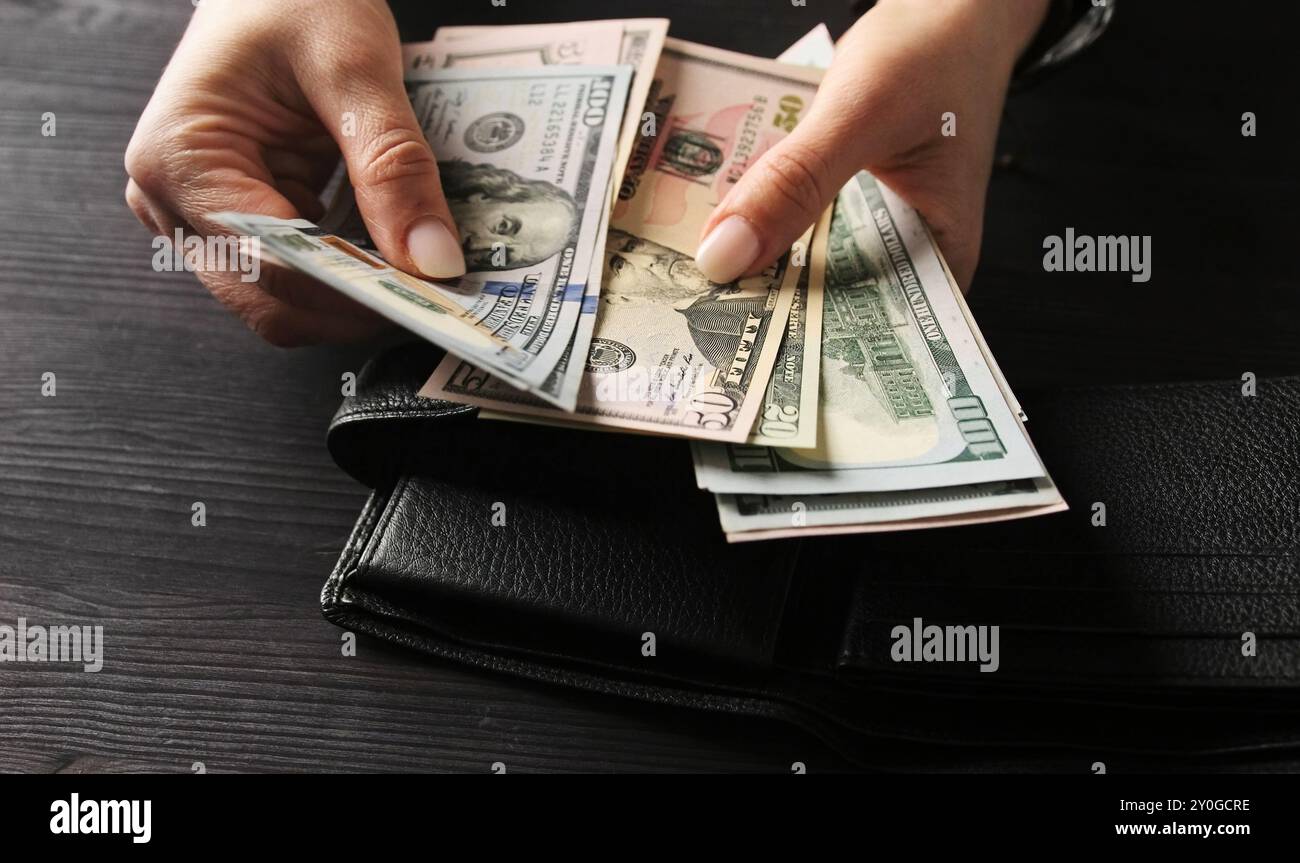 Lady Calculating Her Money Savings In Us Dollar Bills Stock Photo - Alamy
