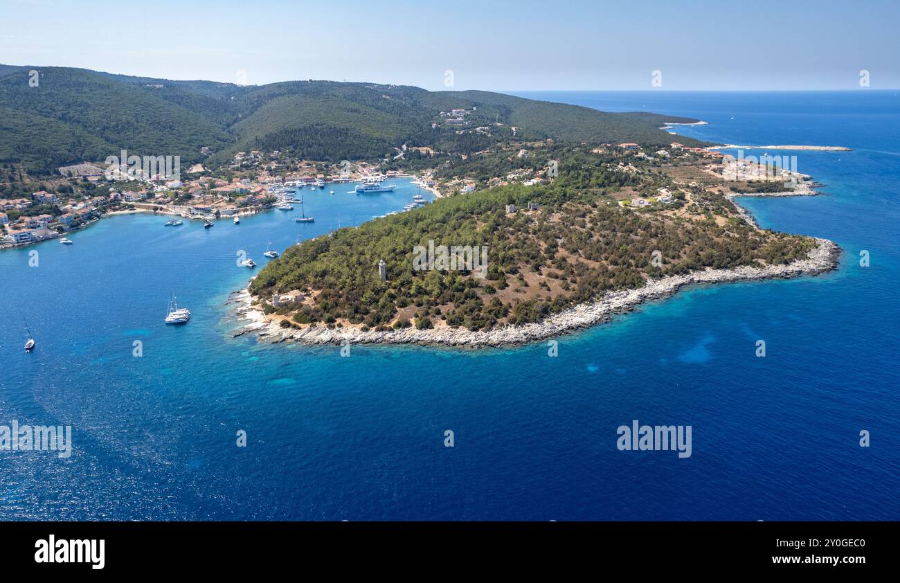 Drone aerial view Greek harbour village of Fiskardo on the Northern tip ...