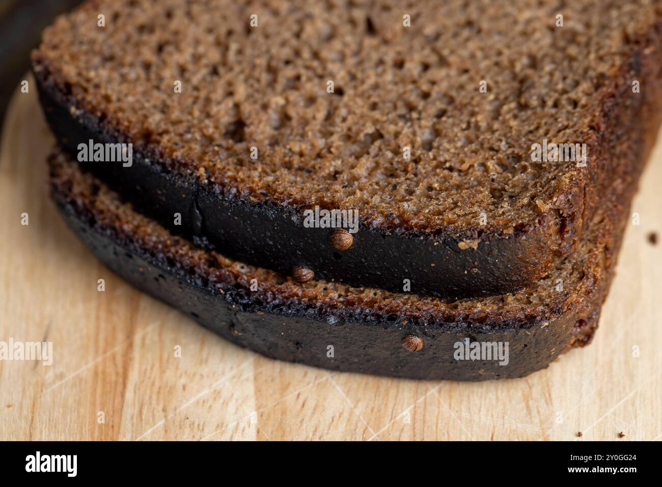 Square loaf of black rye bread Cut into pieces, Sliced black bread made ...