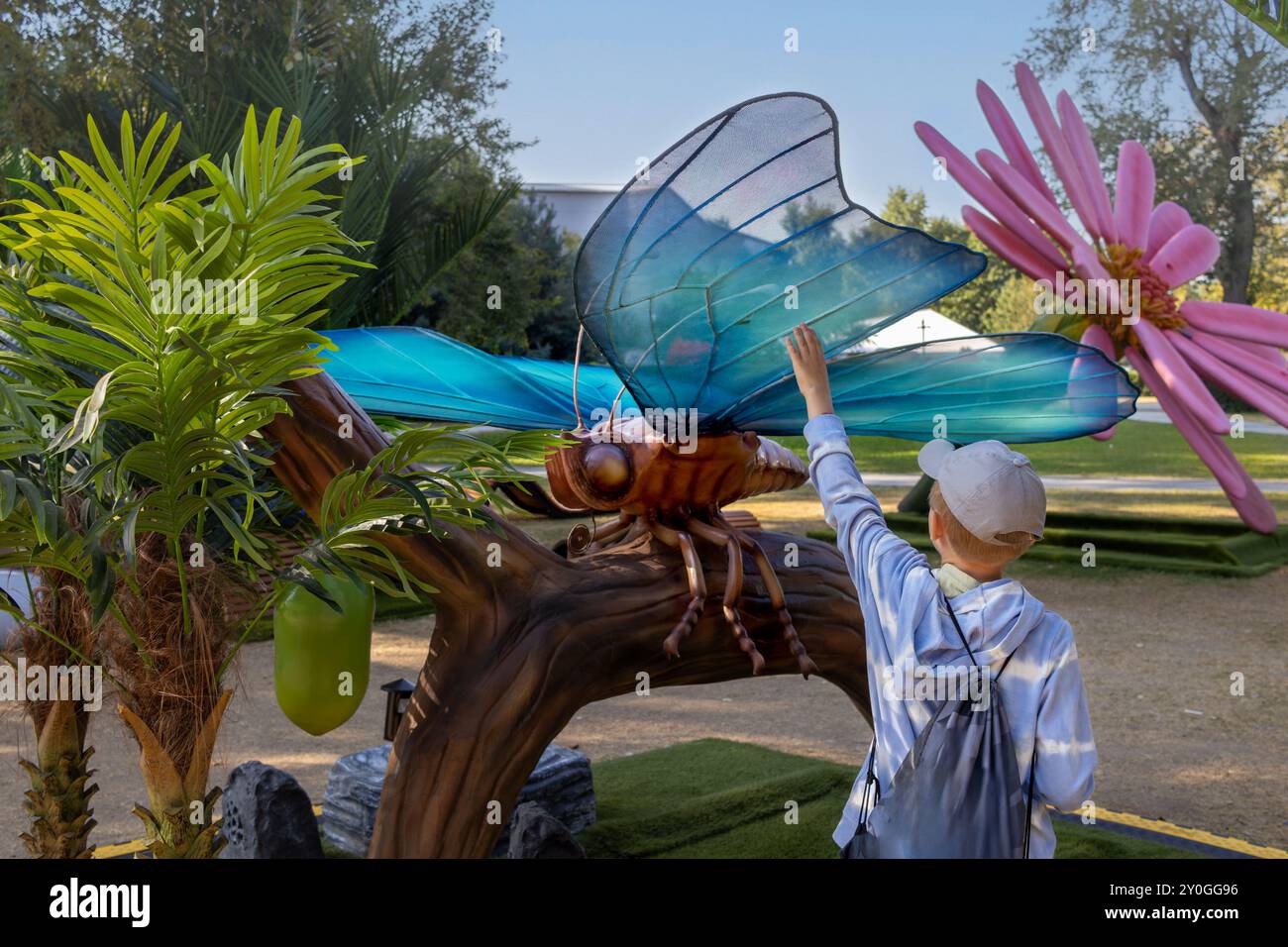 Boy and giant life-sized prehistoric butterfly Stock Photo - Alamy