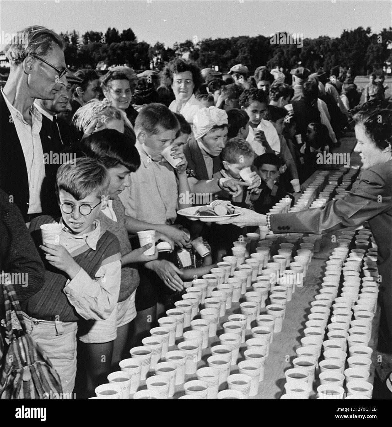 Newly arrived refugees receive food and drink at a picnic at Fort Ontario emergency refugee ...