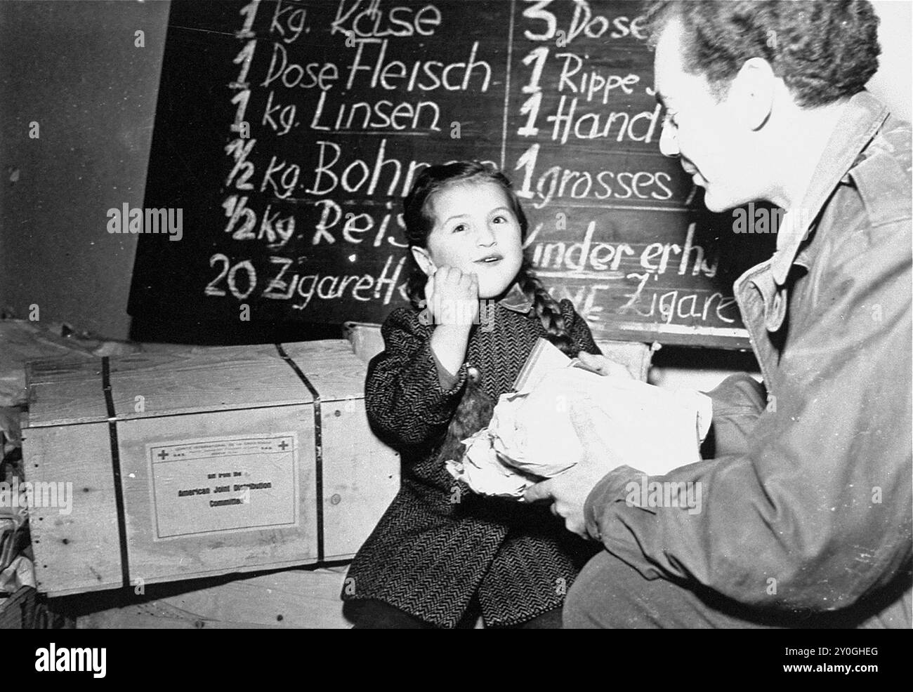A mmber of he American Jewish Joint Distribution Committee, gives food ...