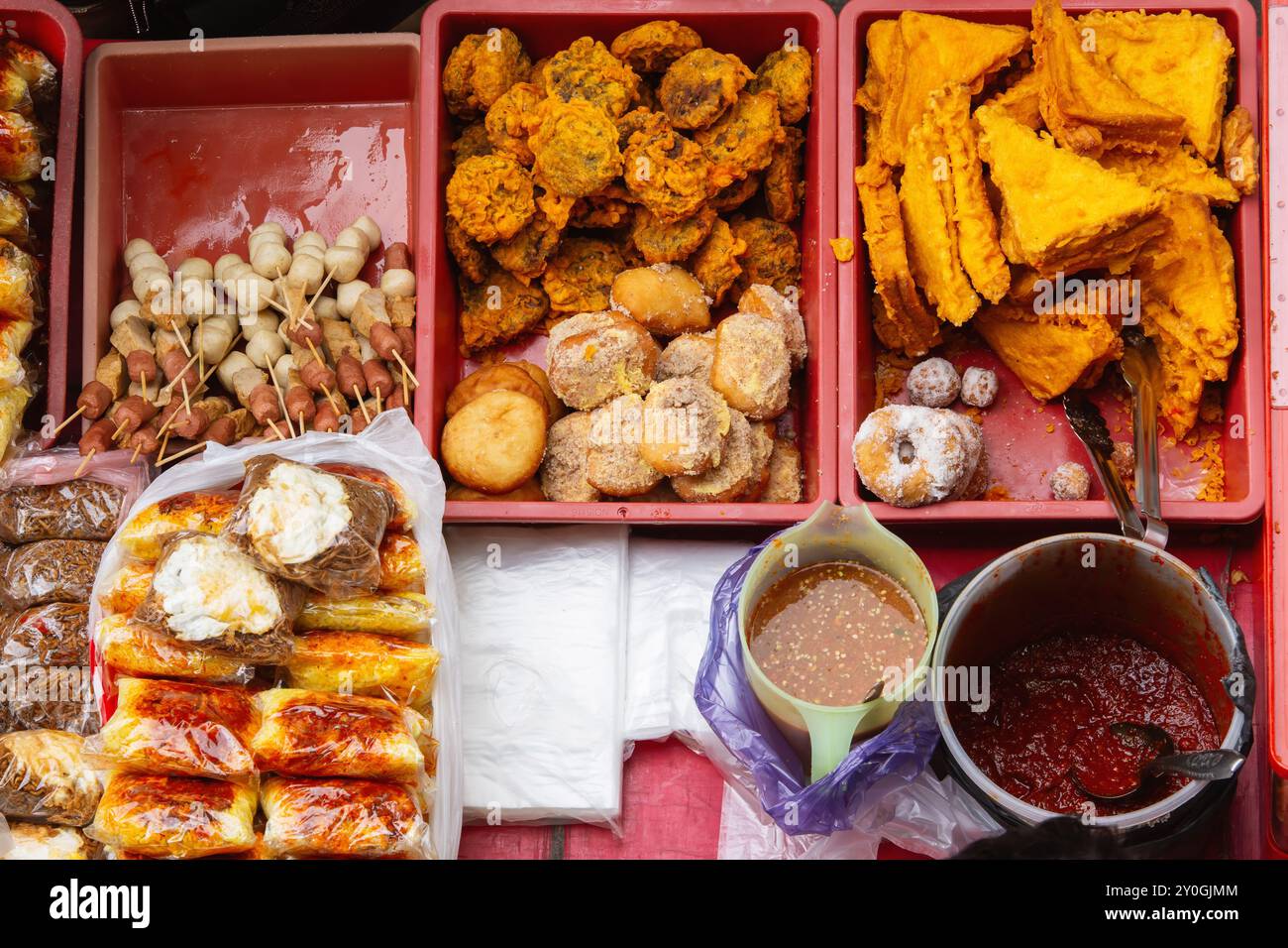 Assorted Malaysian street food selection featuring skewers, kuih and ...