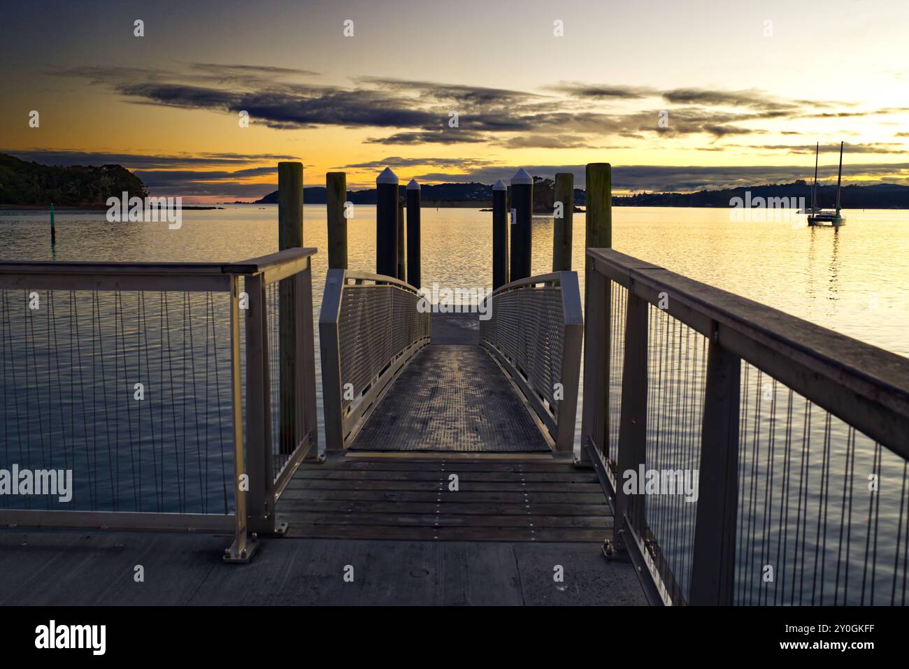 Sunrise at a landing stage at Paihia Wharf, New Zealand. It's the ...