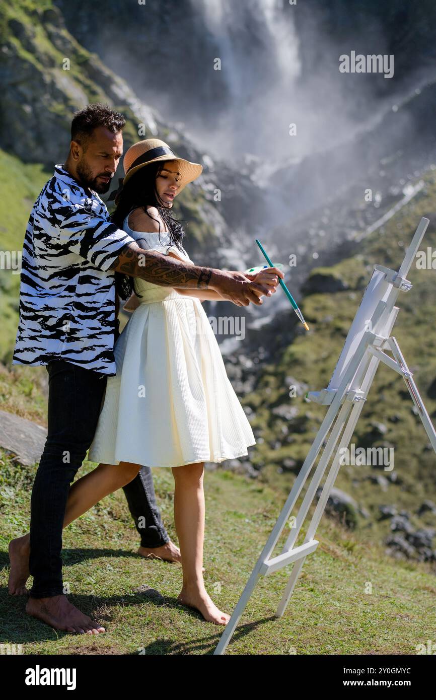 Loving young couple together on nature background. Artist couple in ...