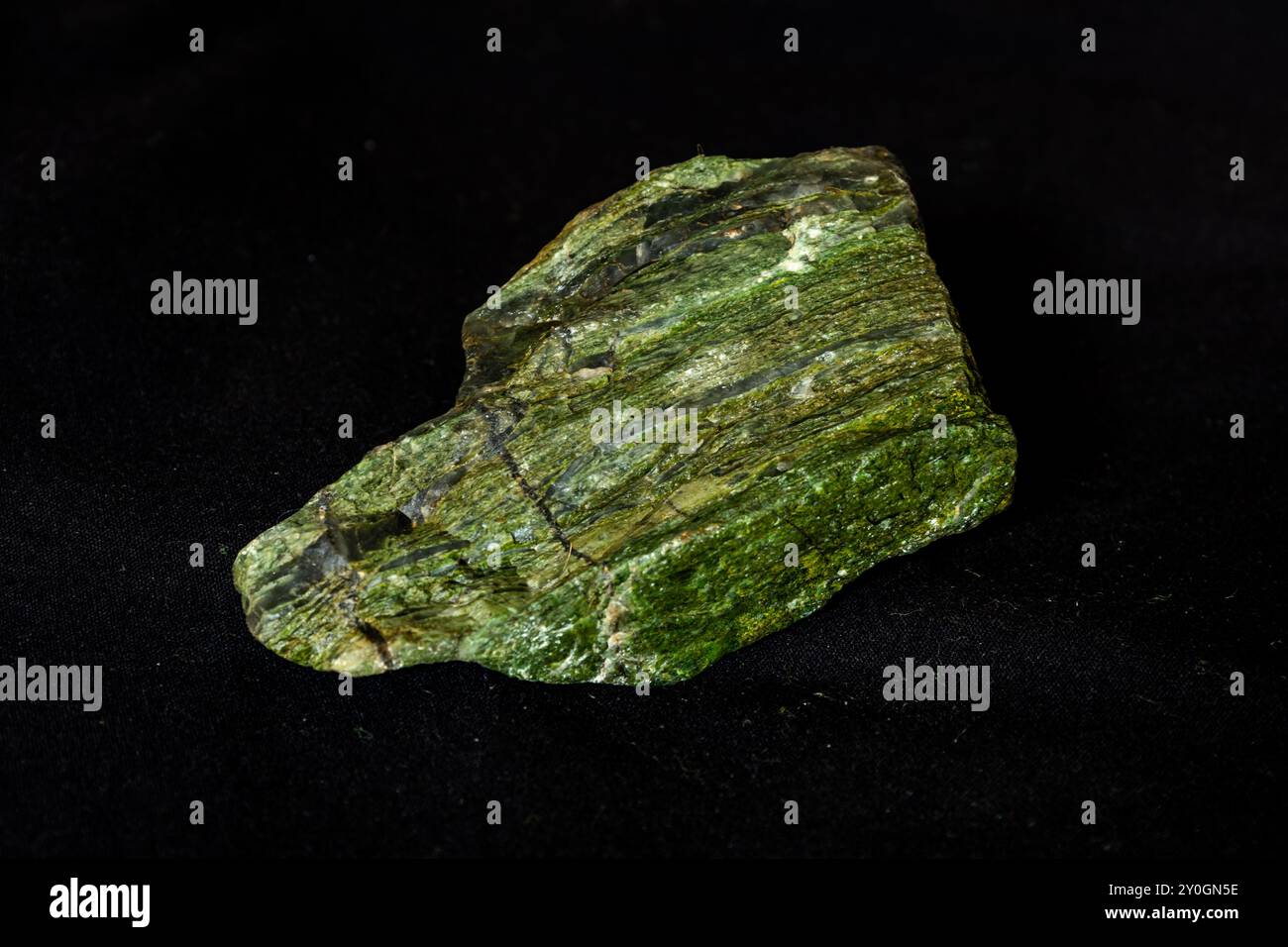 A sample of Fuchsite, with thin bands of chert, on black background ...