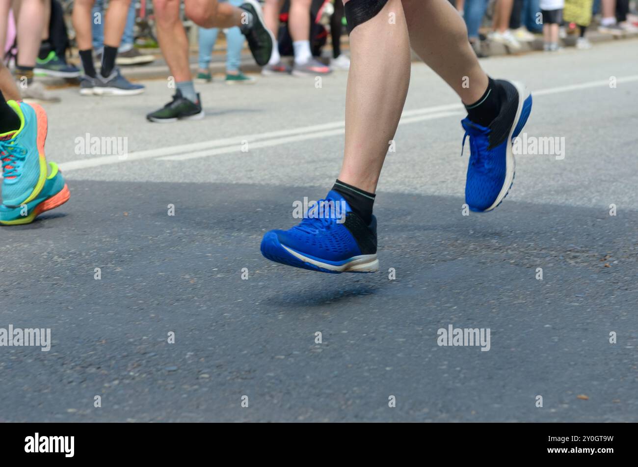 Marathon running race, many runners feet on road racing, sport ...
