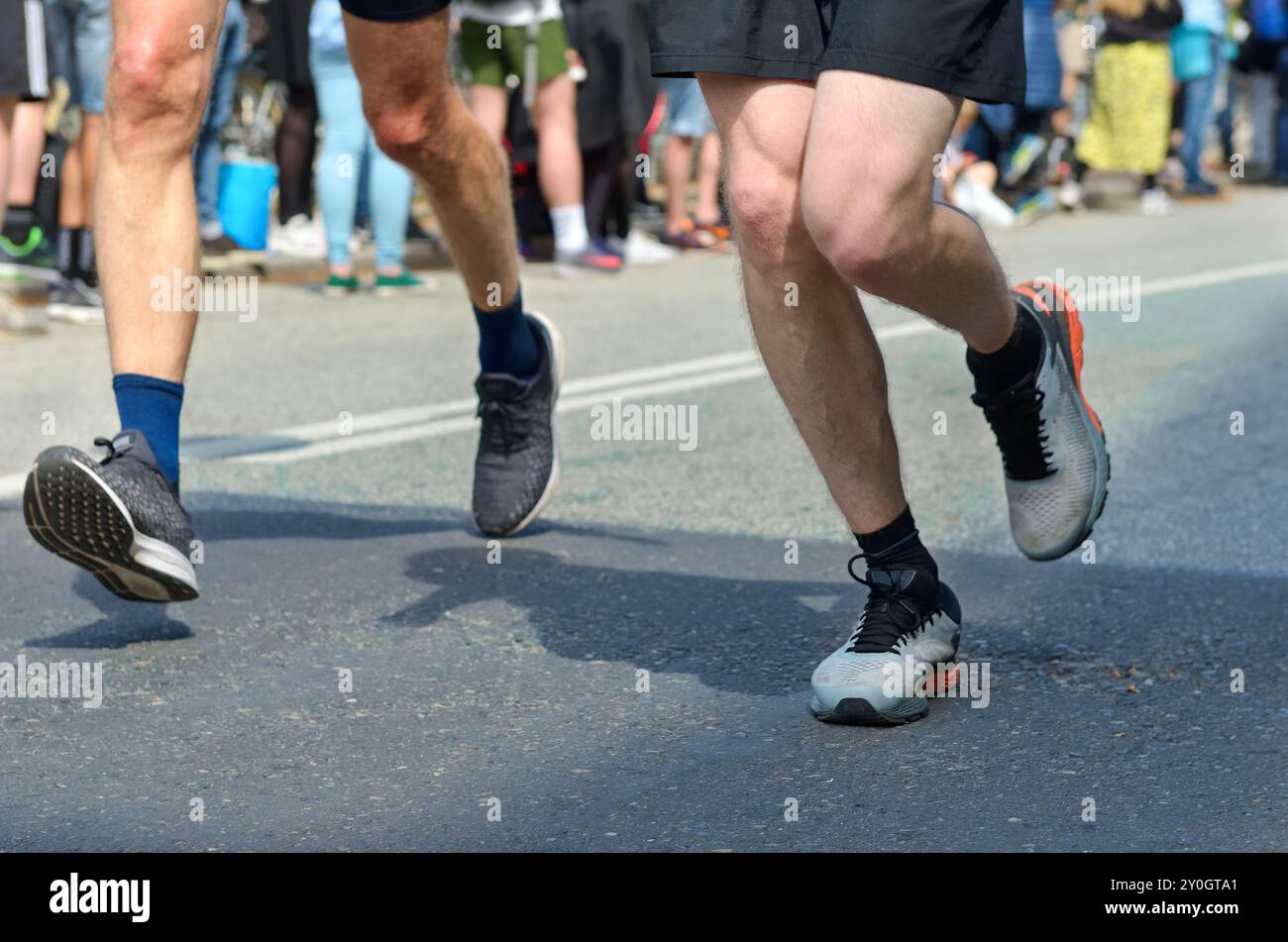 Marathon running race, many runners feet on road racing, sport ...