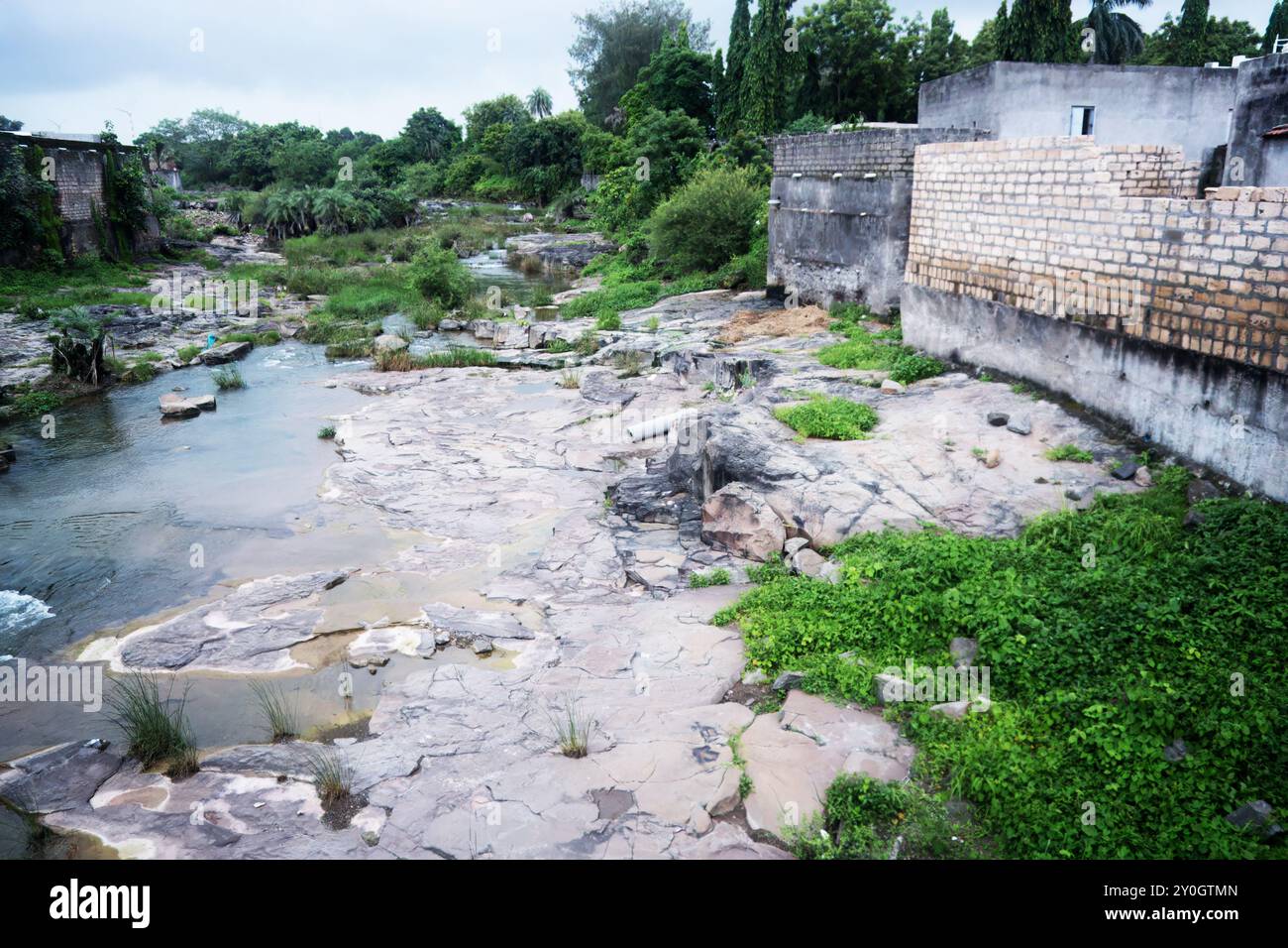 Serene Stream Flowing Through Lush Landscape Beside Urban Encroachment ...