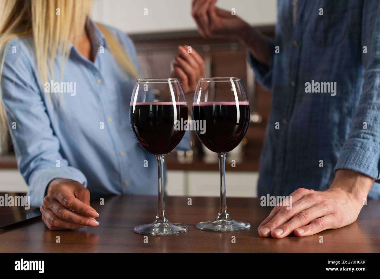 Close-up happy couple having fun and toasting standing on a kitchen ...