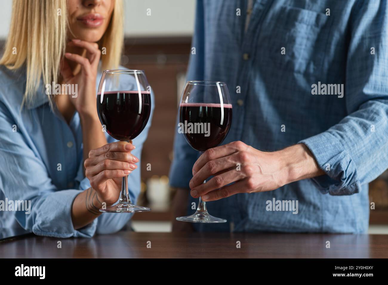 Close-up happy couple having fun and toasting standing on a kitchen ...