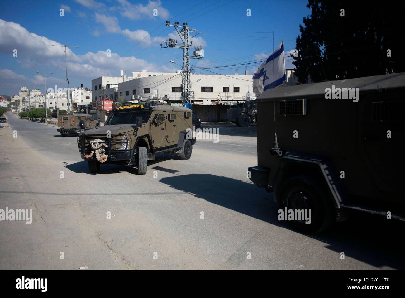 Military vehicles belonging to the Israeli army patrol the streets and ...