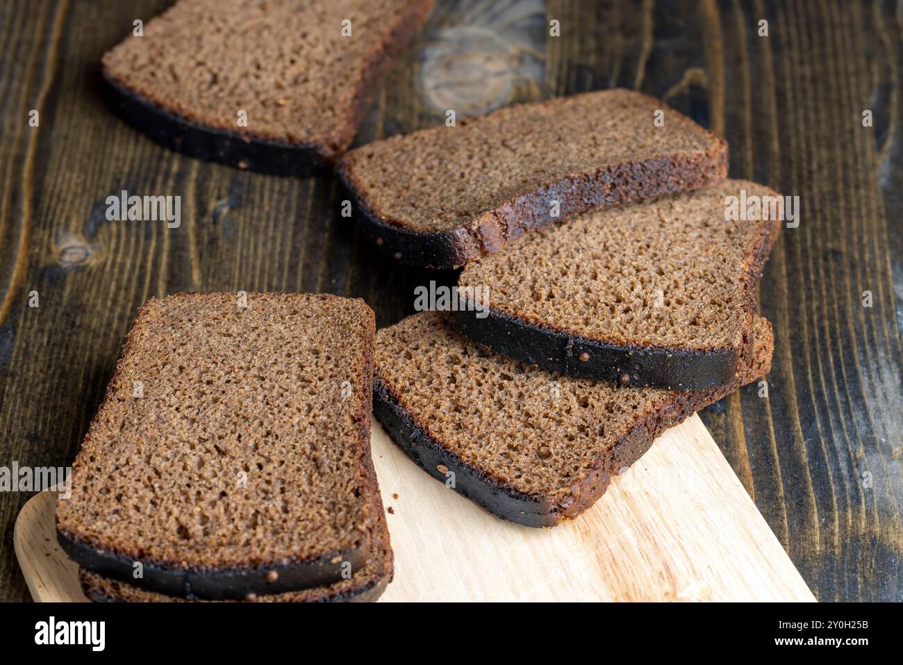 Square loaf of black rye bread Cut into pieces, Sliced black bread made ...
