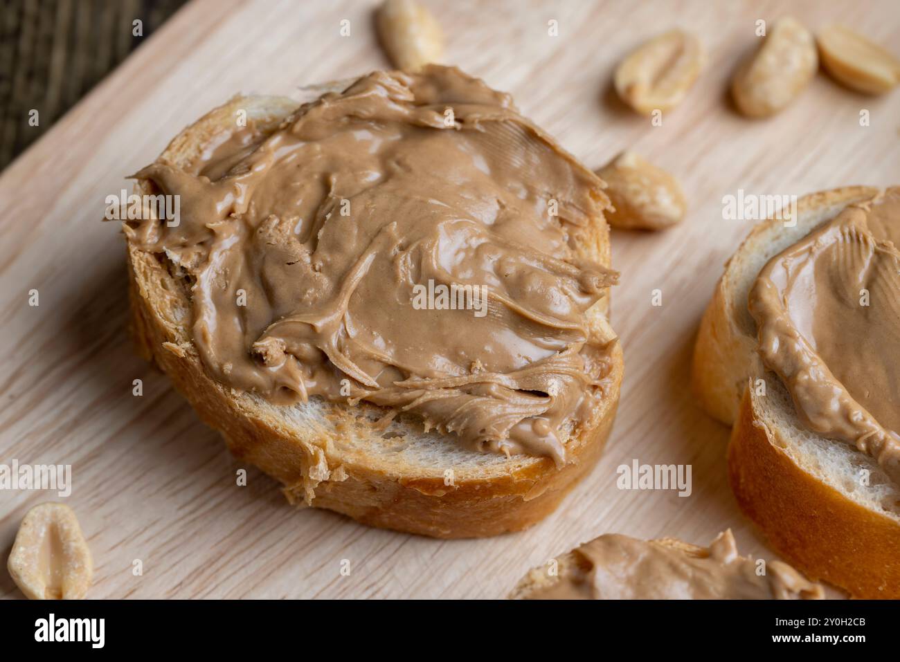 Peanut paste on a soft wheat baguette, made from peanut paste while ...