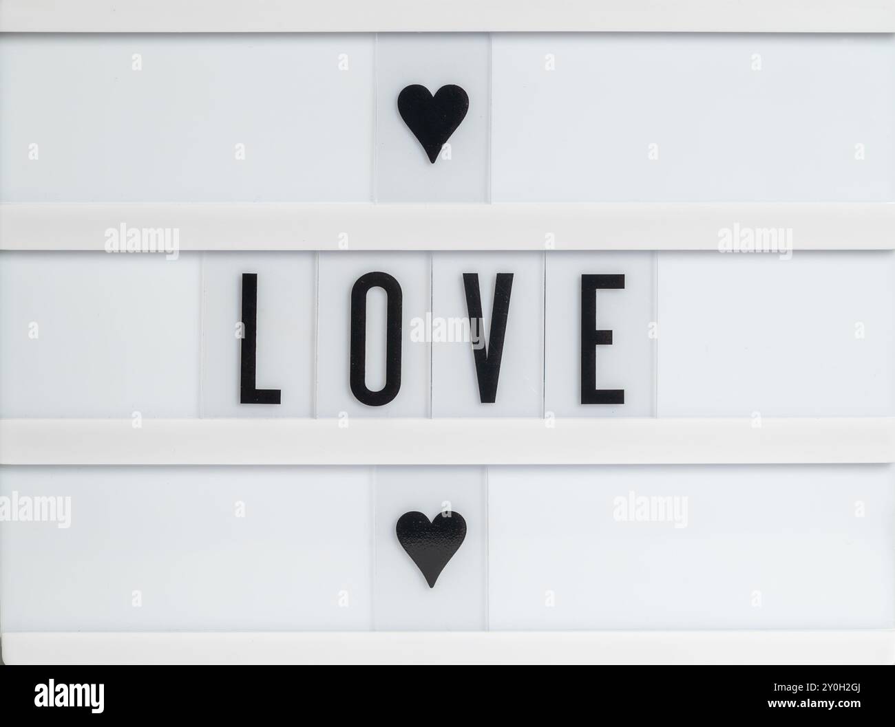 White message board with the word love with 2 hearts above and below it ...