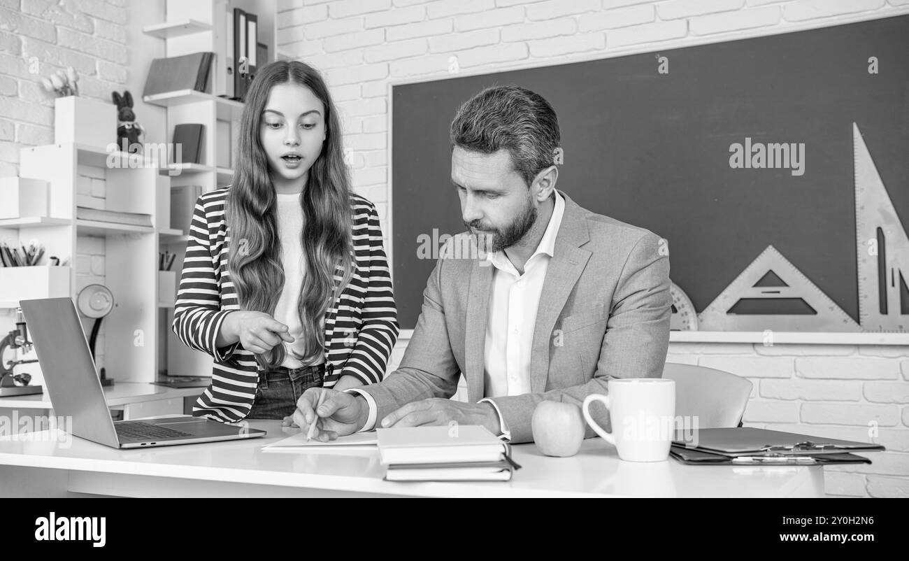 surprised child study in classroom with teacher Stock Photo - Alamy