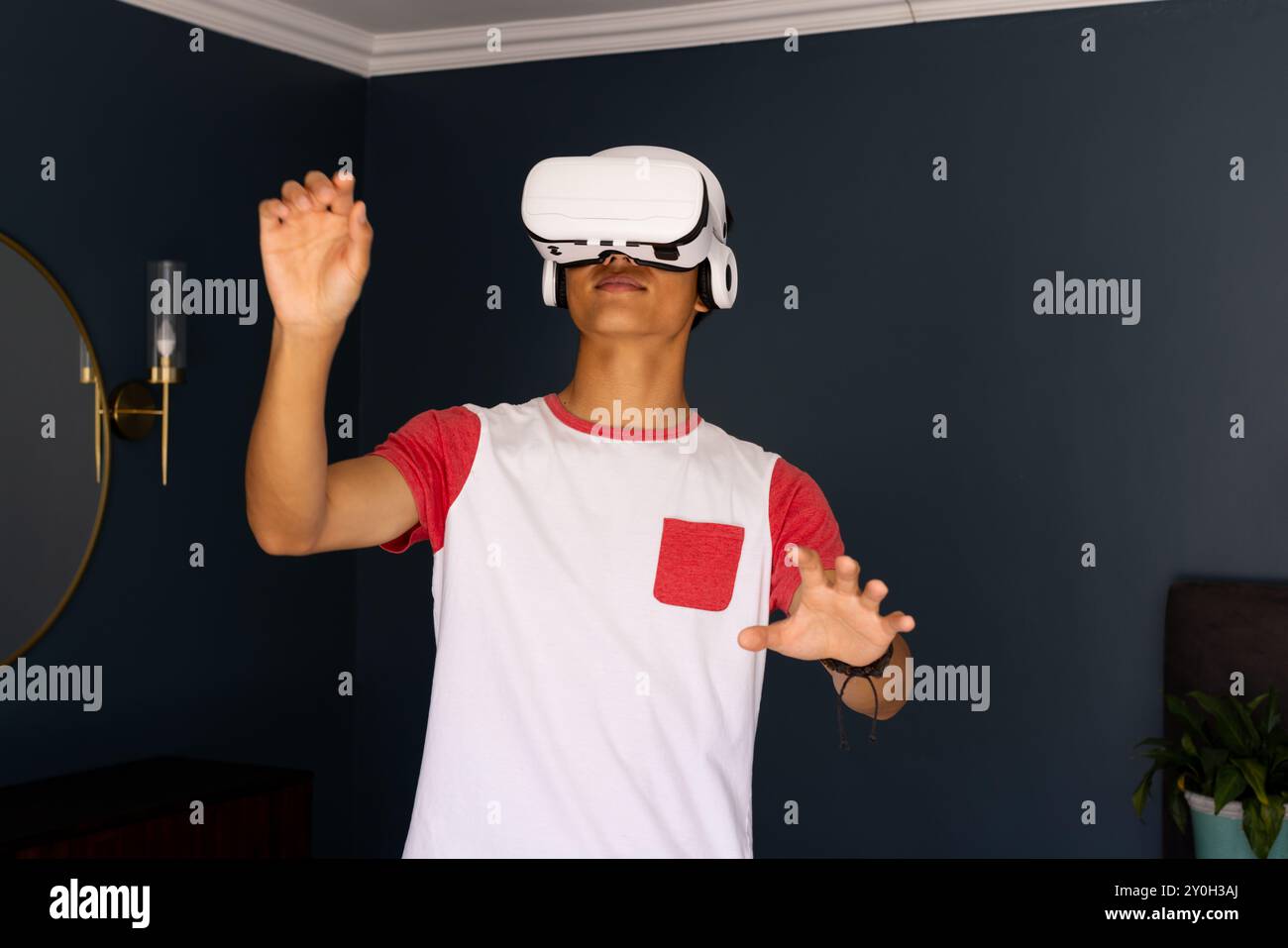 Using VR headset, young asian man interacting with virtual environment ...