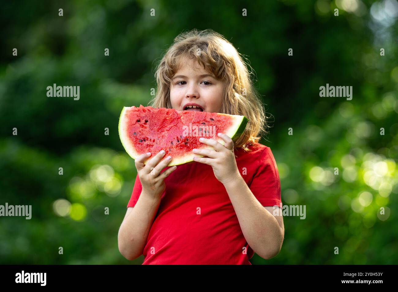 Summer portrait of Kid with watermelon. Cute blonde kid eating ...