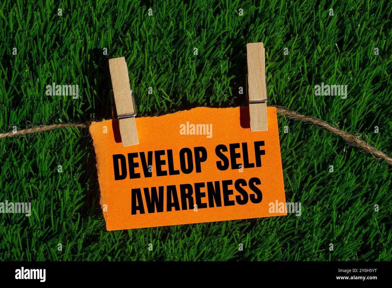 Develop self awareness message written on ripped torn orange paper ...