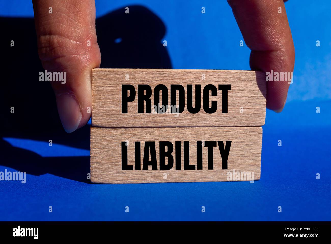 Product liability message written on wooden blocks with blue background ...