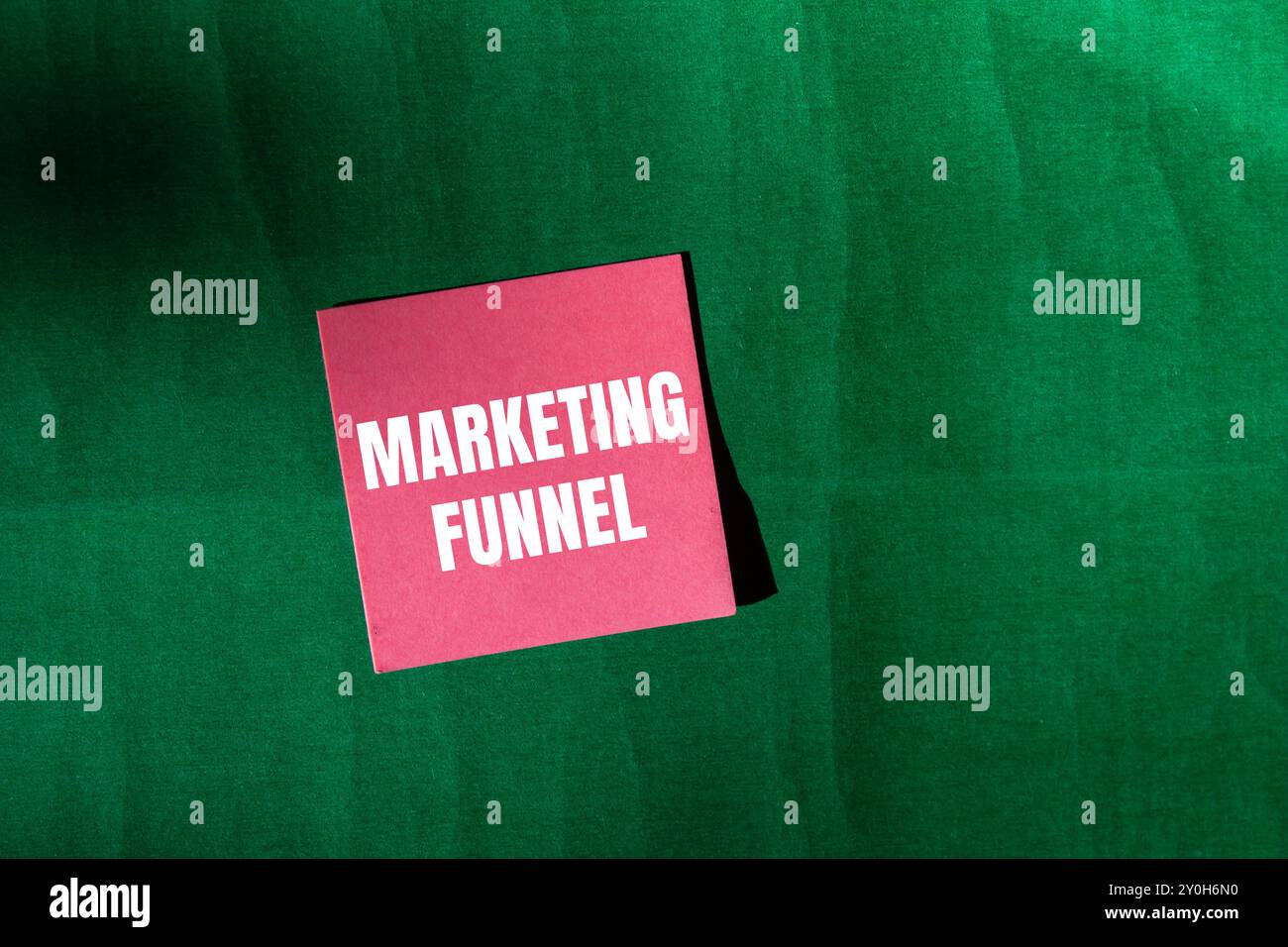 Marketing funnel message written on pink paper with green background ...