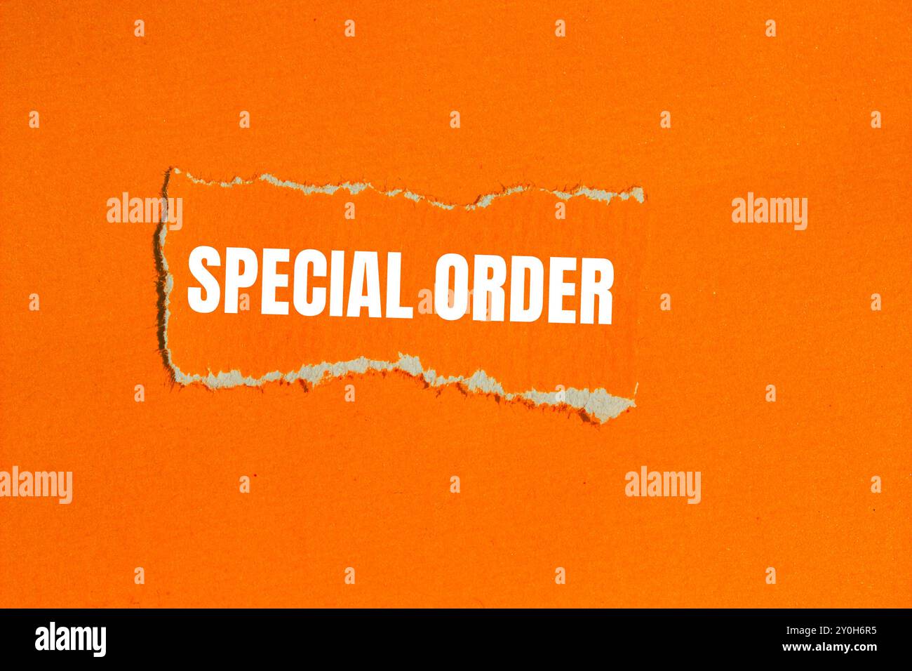Special order message written on ripped torn orange paper with orange background. Conceptual ...