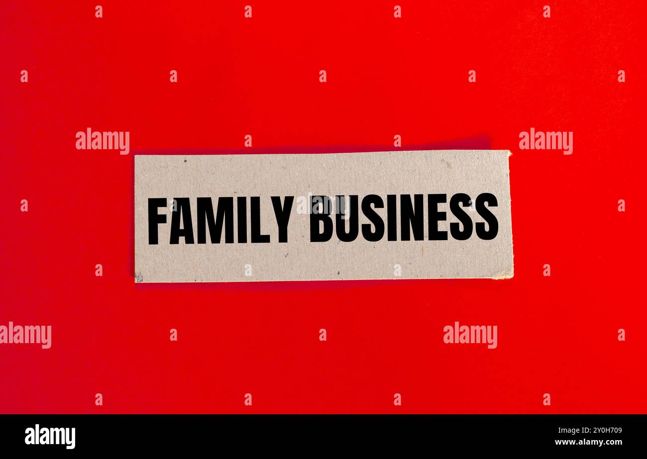Family business message written on paper piece with red background ...