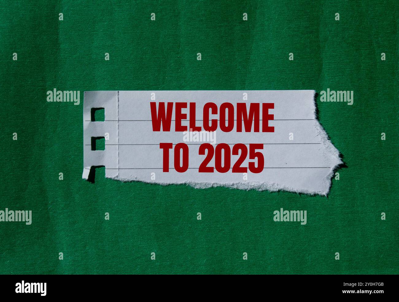 Welcome to 2025 message written on ripped torn paper with green ...