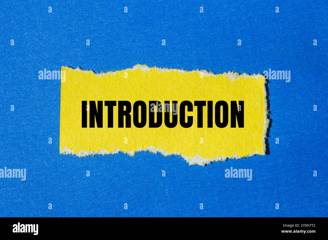 Introduction message written on ripped yellow torn paper piece with ...