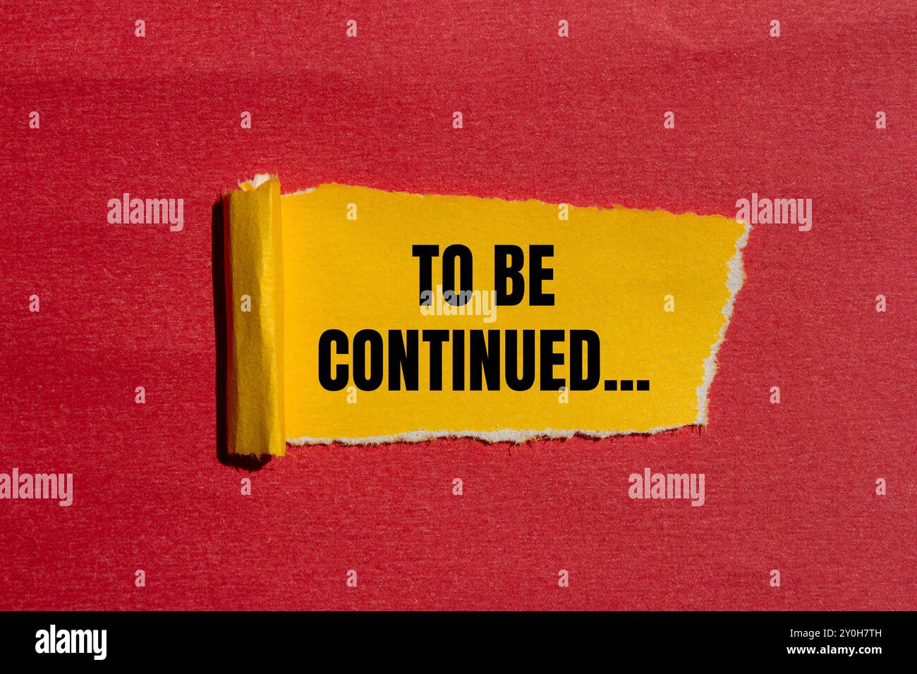To be continued message written on ripped torn yellow paper with red ...