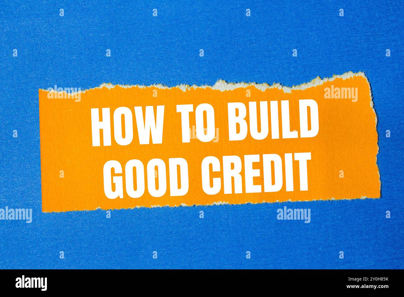 How to build good credit message written on ripped torn orange paper ...