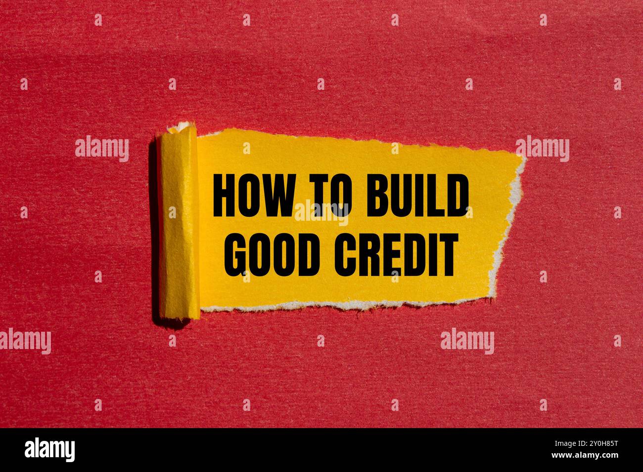 How to build good credit message written on ripped torn yellow paper ...