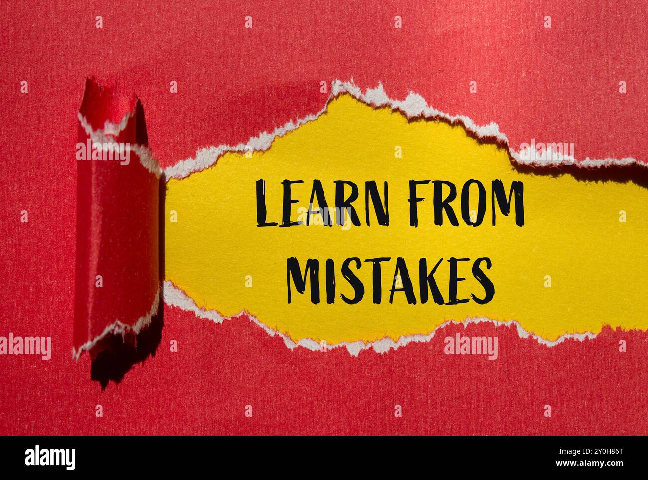 Learn from mistakes message written on ripped torn red paper with ...