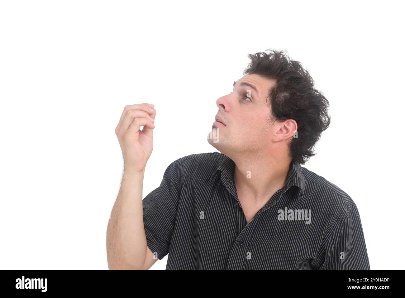 puzzled young man with clueless face expression and pinched fingers ...