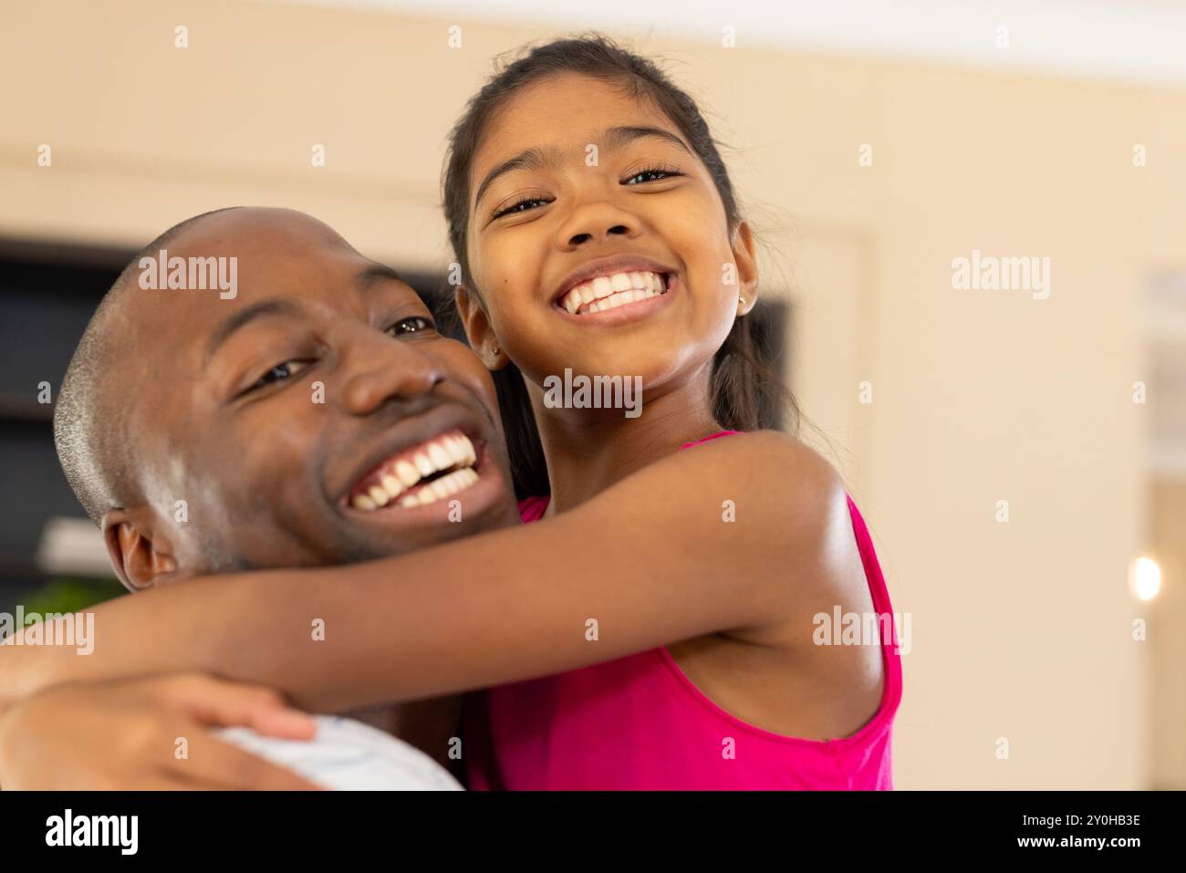 Father and daughter smiling and hugging, enjoying quality family time ...