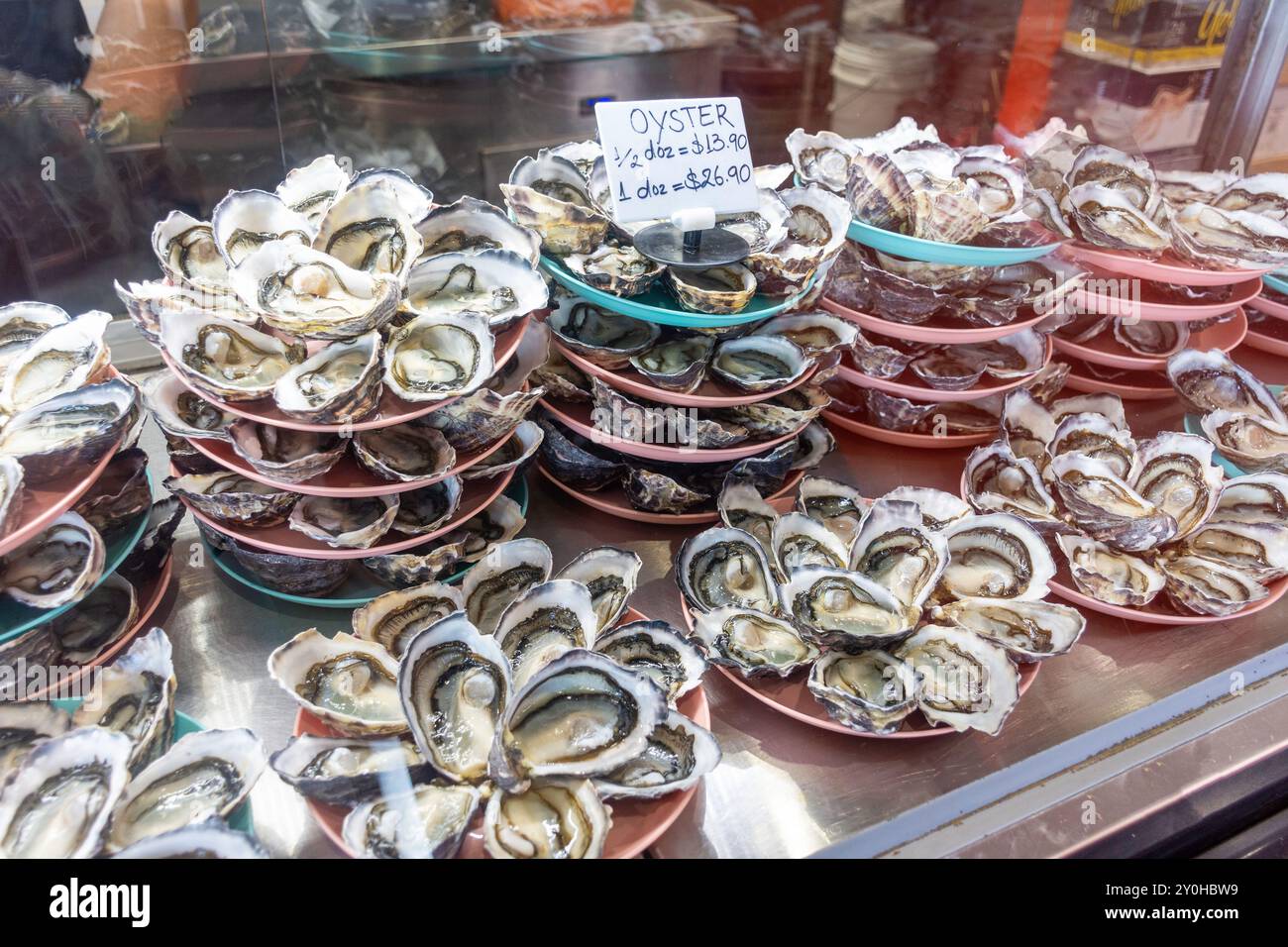 Plates of fresh oysters at harbourfront restaurant, Stokes Hill Wharf ...