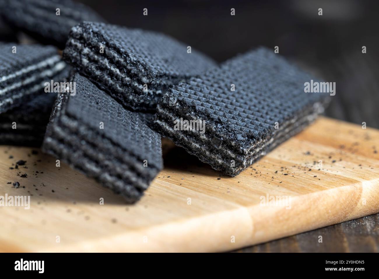 Crispy black waffles with cream filling, close-up of sweet black ...