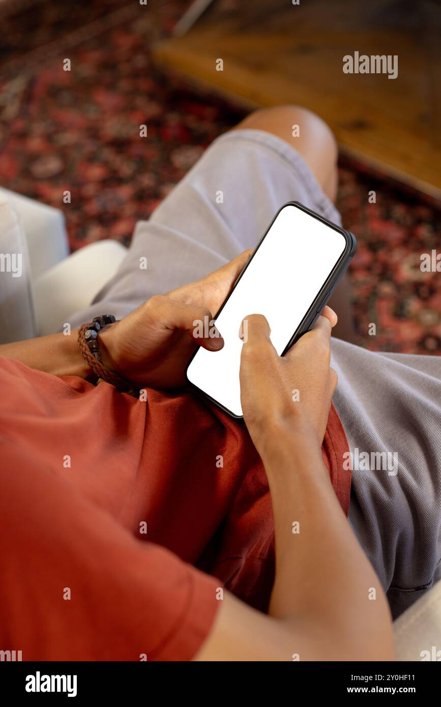 Using smartphone, person scrolling on blank screen while sitting on couch, copy space Stock ...