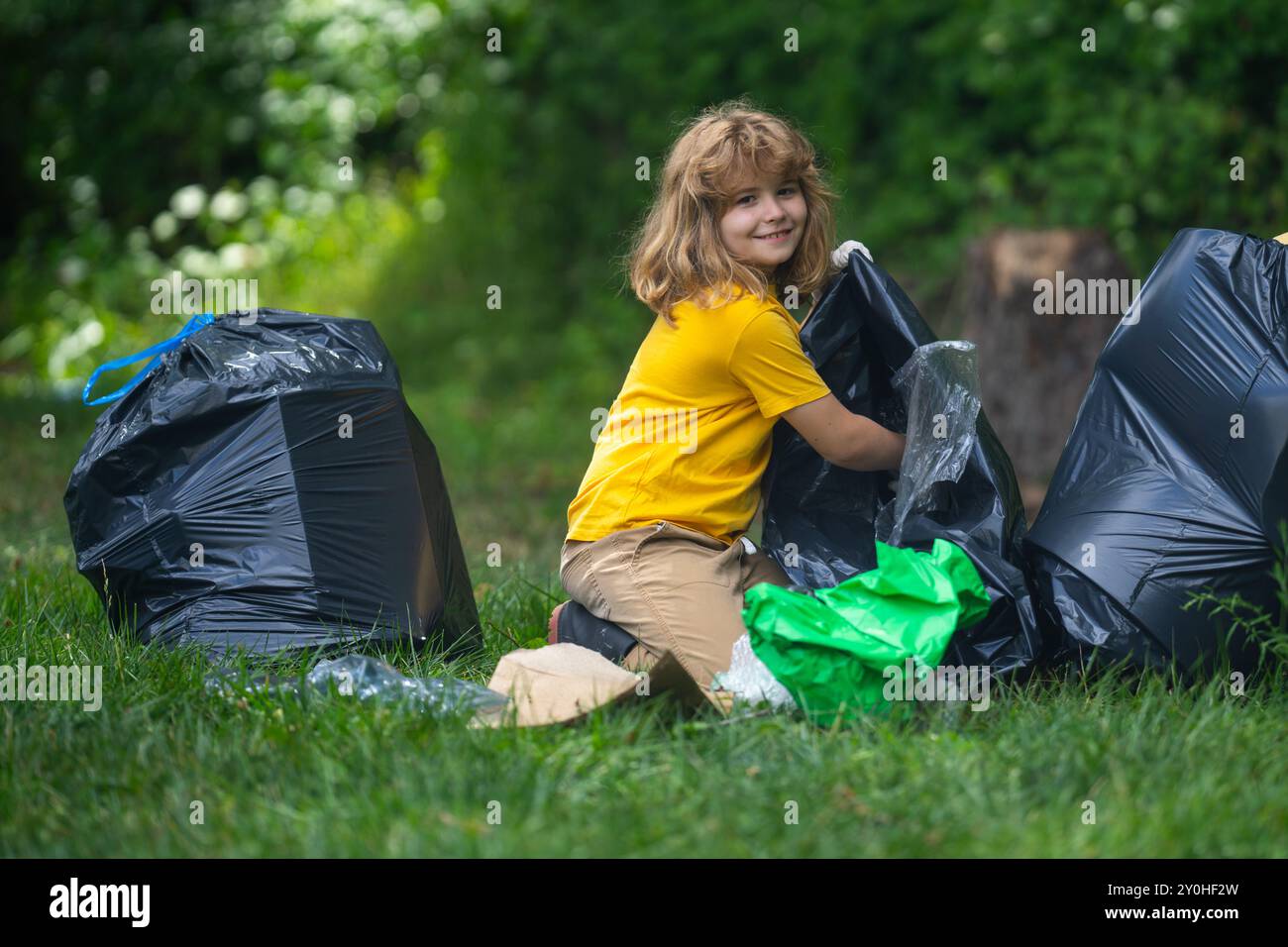 Child collecting trash outside. Ecology concept. Environmental ...