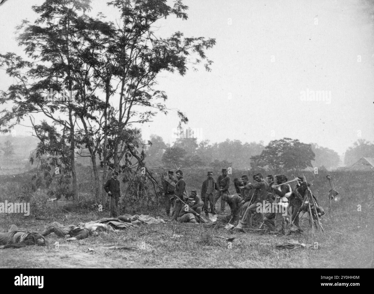 Union soldiers standing near the bodies of dead Confederate soldiers ...