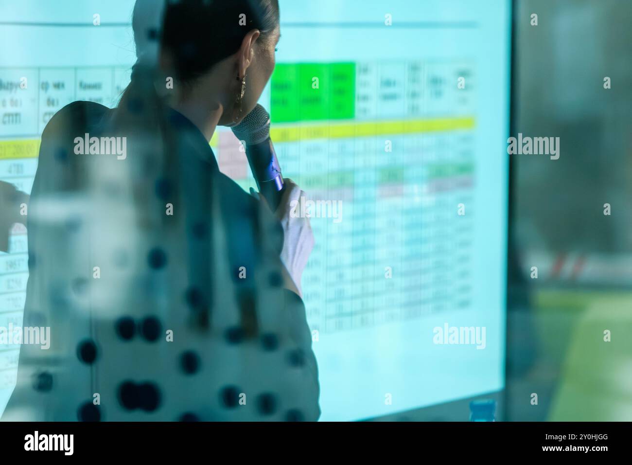 Businesswoman delivering an engaging presentation with a colorful data ...