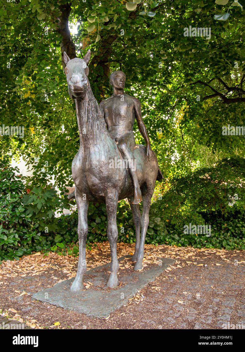 Bronze statue of a rider on horseback by Elisabeth Frink surrounded by ...