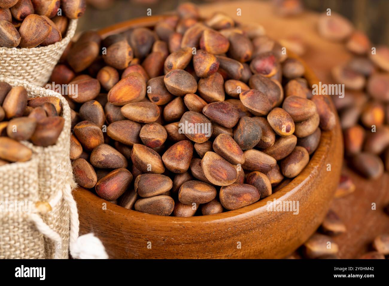 Unpeeled pine nuts on the table, a bunch of pine nuts in the shell ...