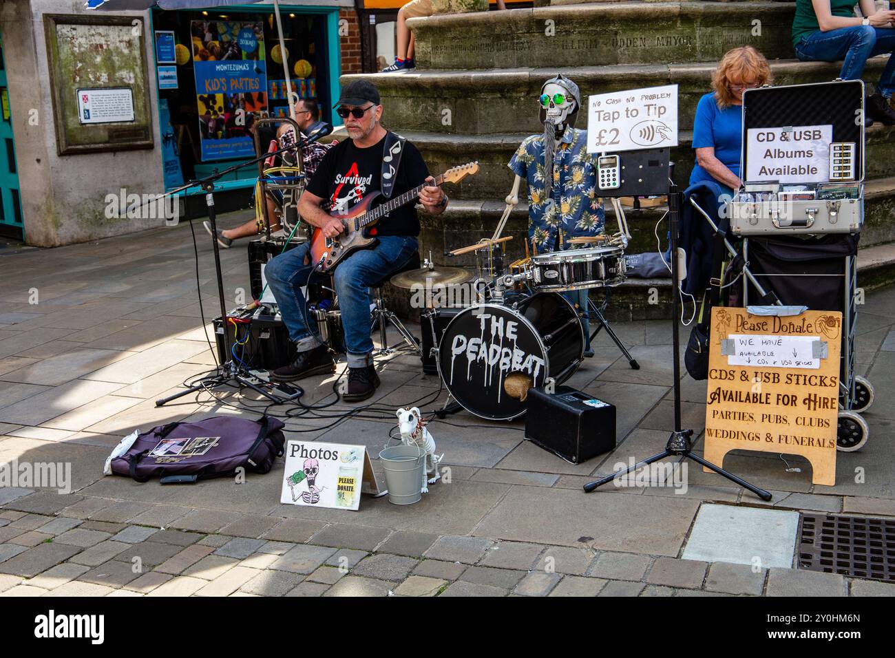 Street performer playing music in a busy urban setting, featuring a ...