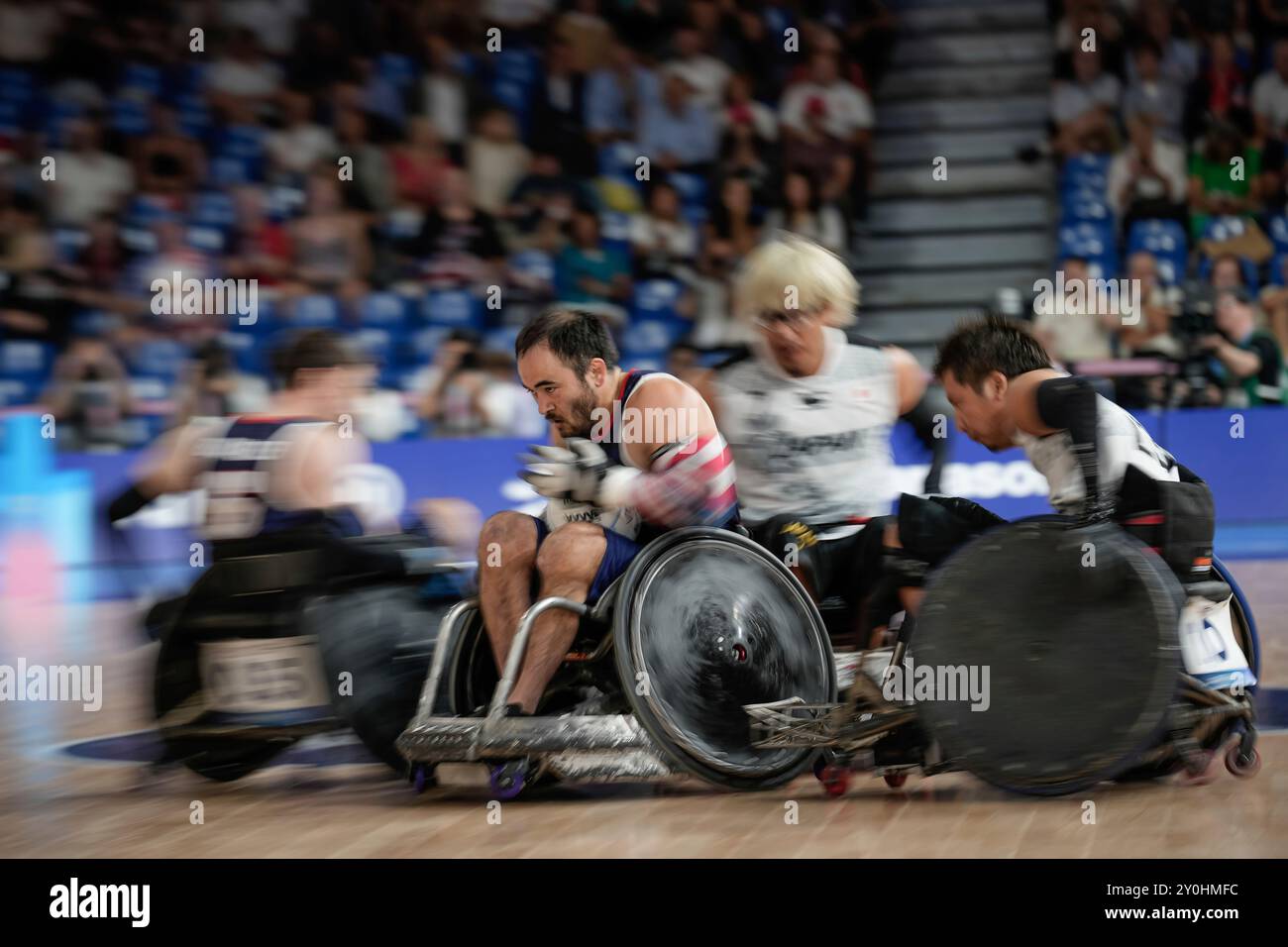 Chuck Aoki from the U.S. holds the ball during the wheelchair rugby ...
