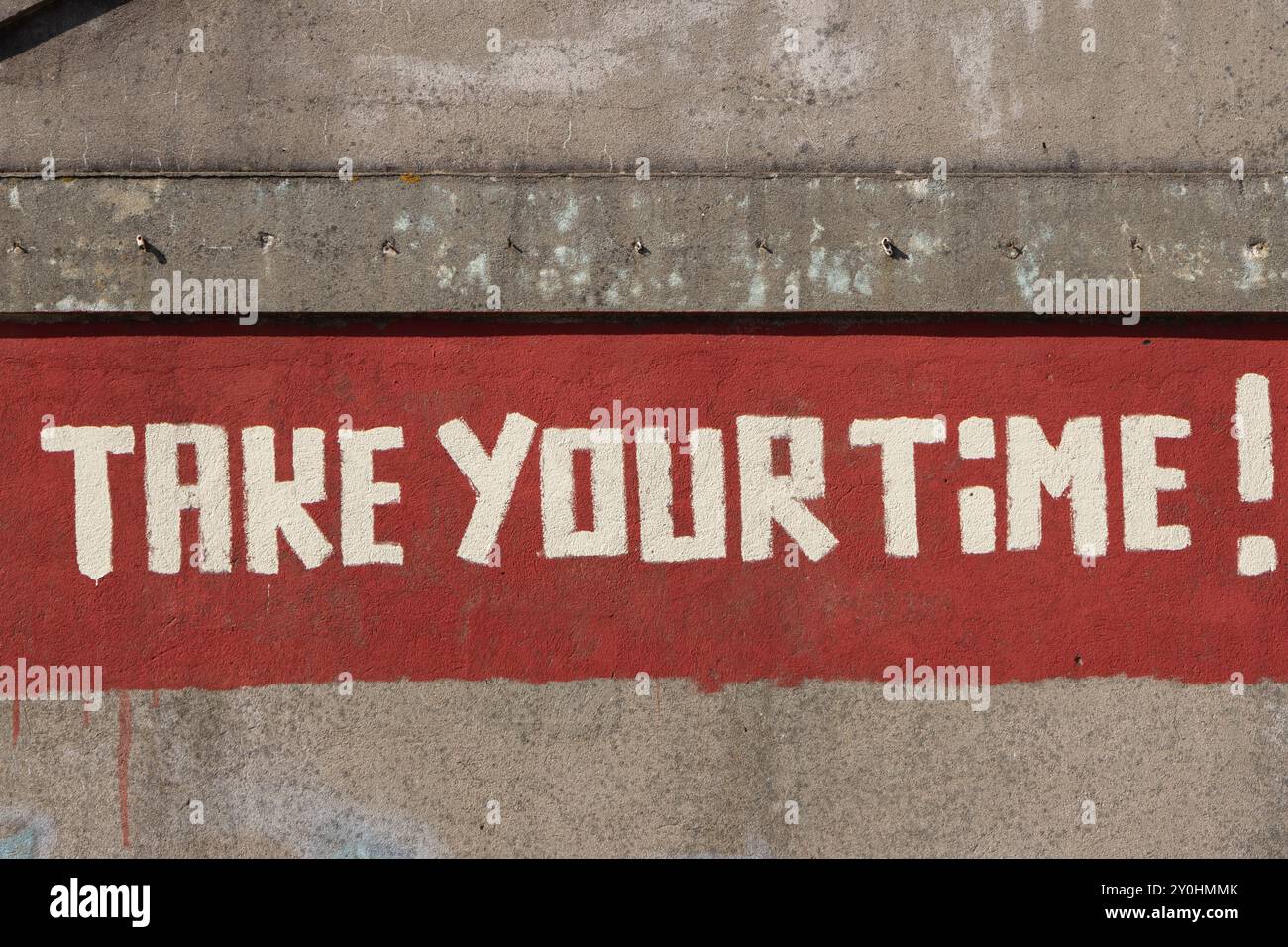 White lettering painted on a red background, encouraging viewers to ...